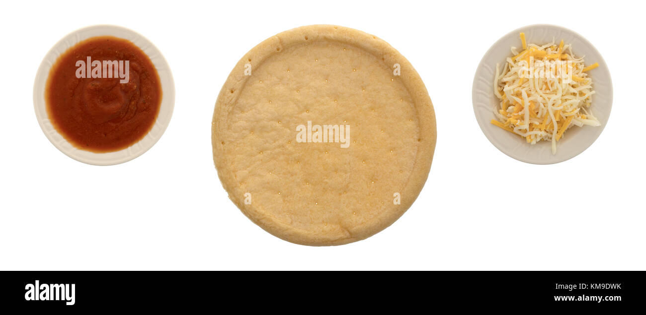 Top view of a pizza crust with tomato sauce and a blend of cheeses in ...