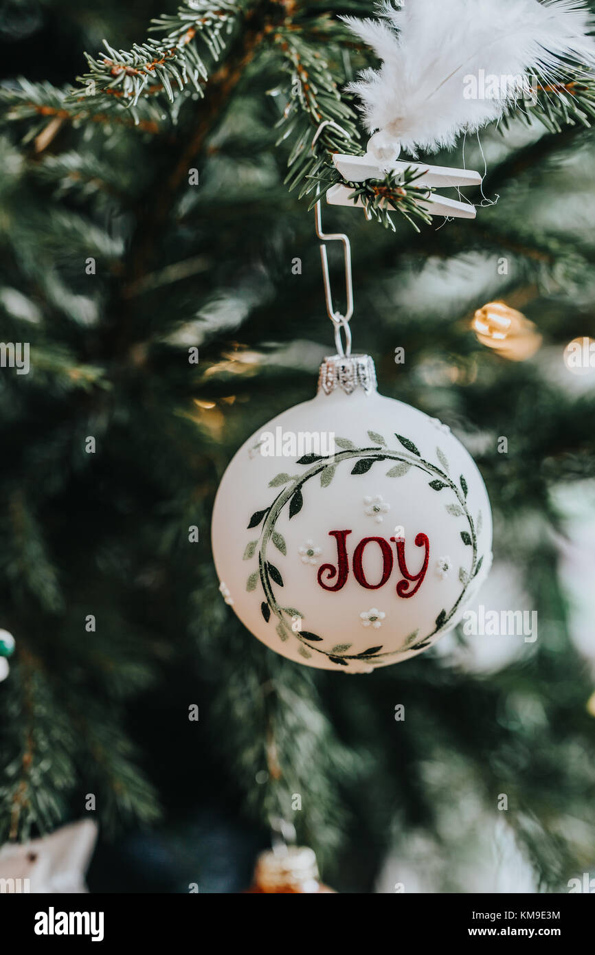 Joy Bauble hanging on a Christmas tree Stock Photo - Alamy