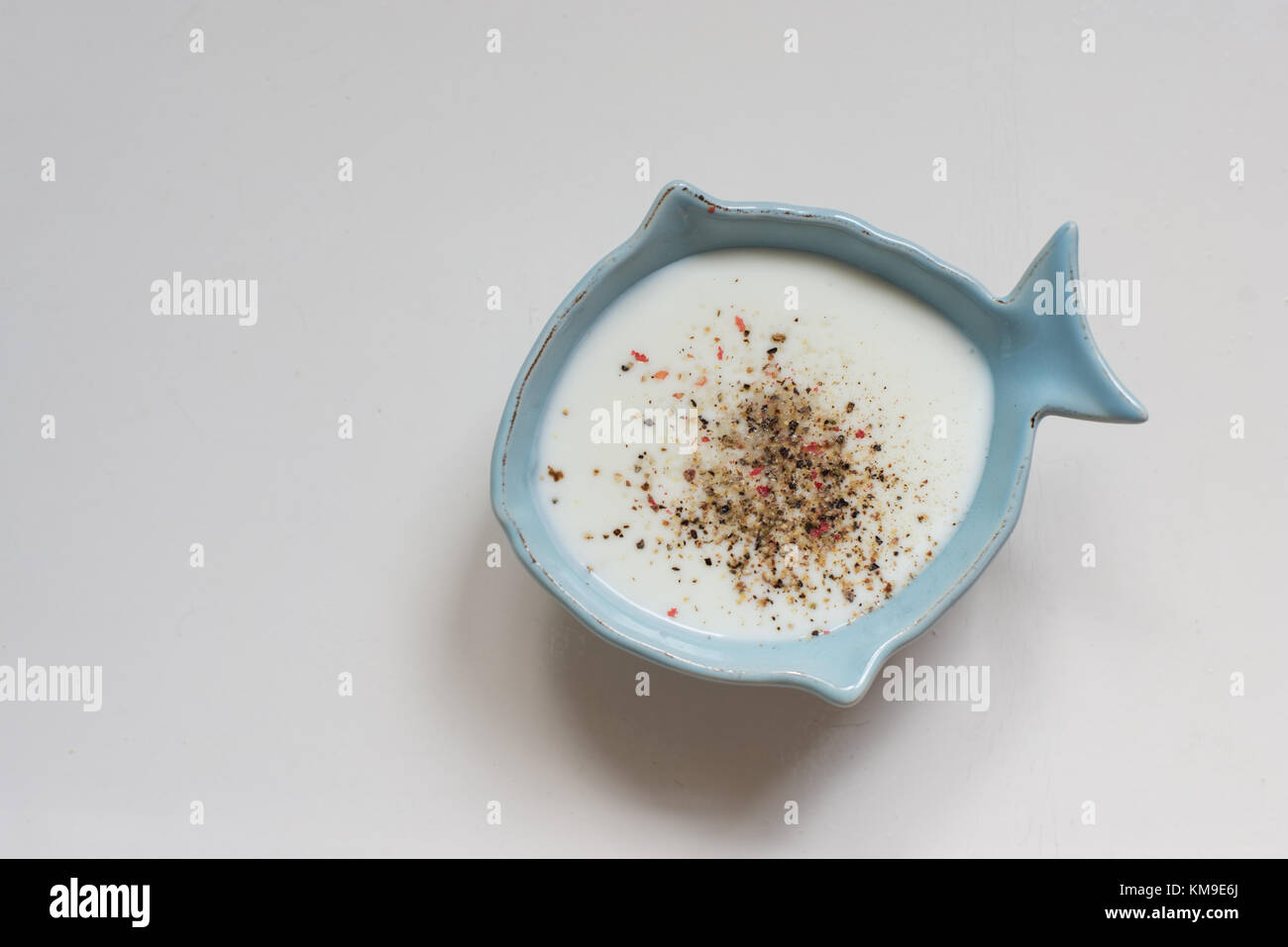 Yogurt dip with pepper in a fish shaped bowl Stock Photo - Alamy