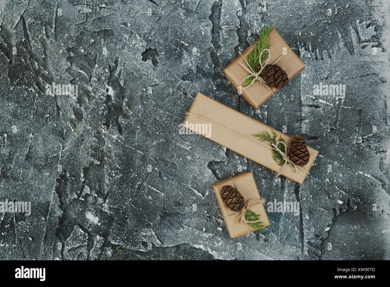 Three wrapped Christmas gifts on a textured grey background Stock Photo ...