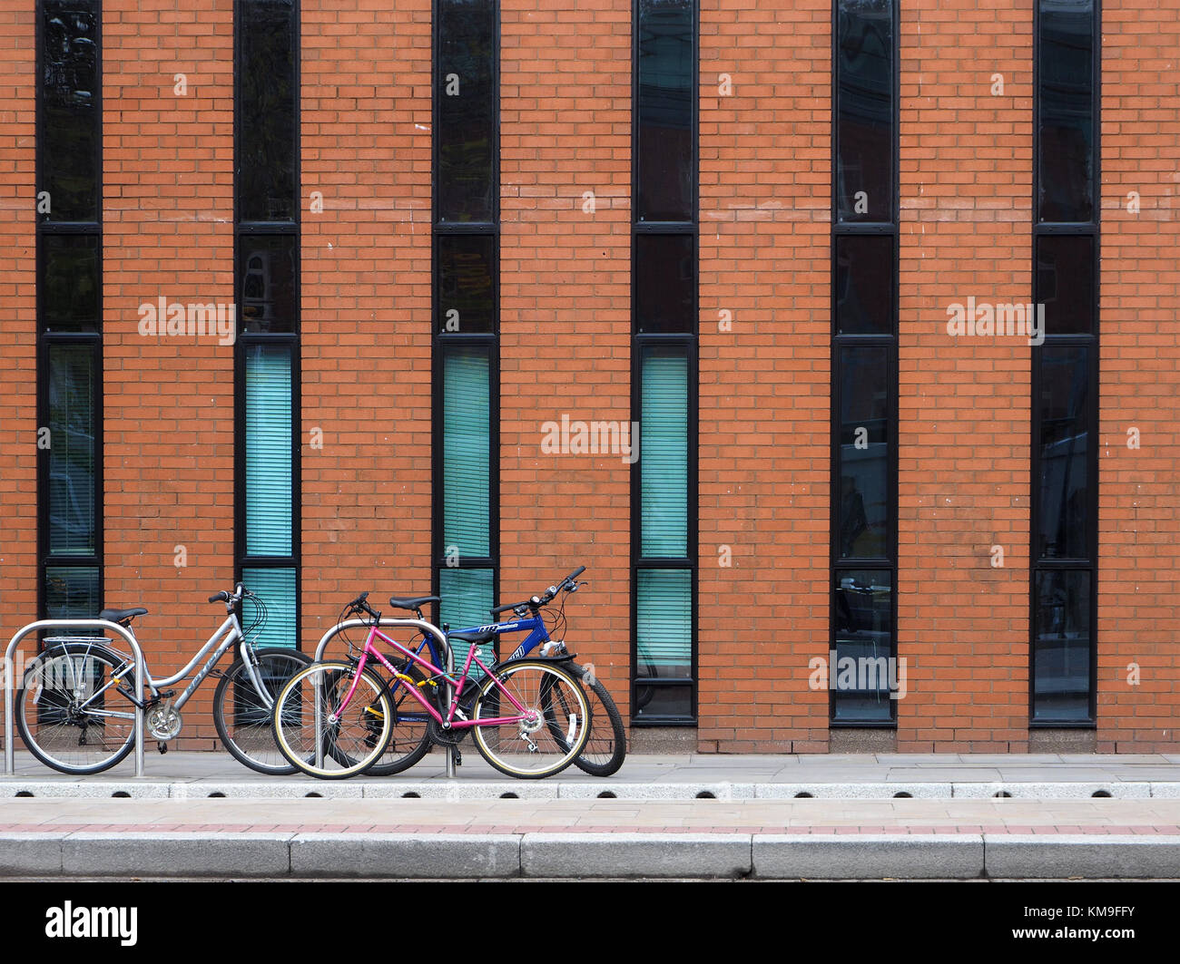 pattern of bicycles parked beside brickwork facade of The Kilburn ...