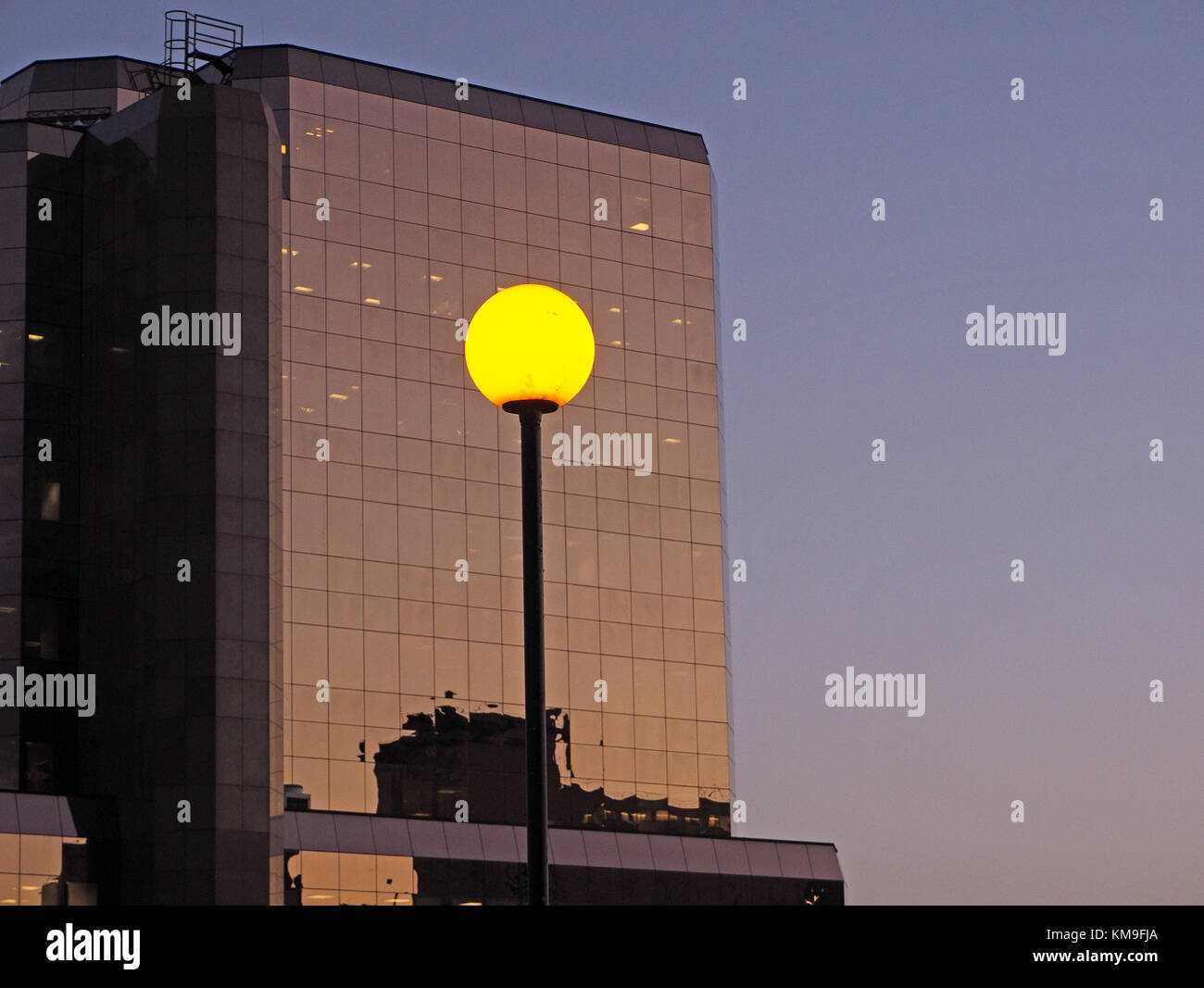 gold street light with background of evening reflections at dusk in ...