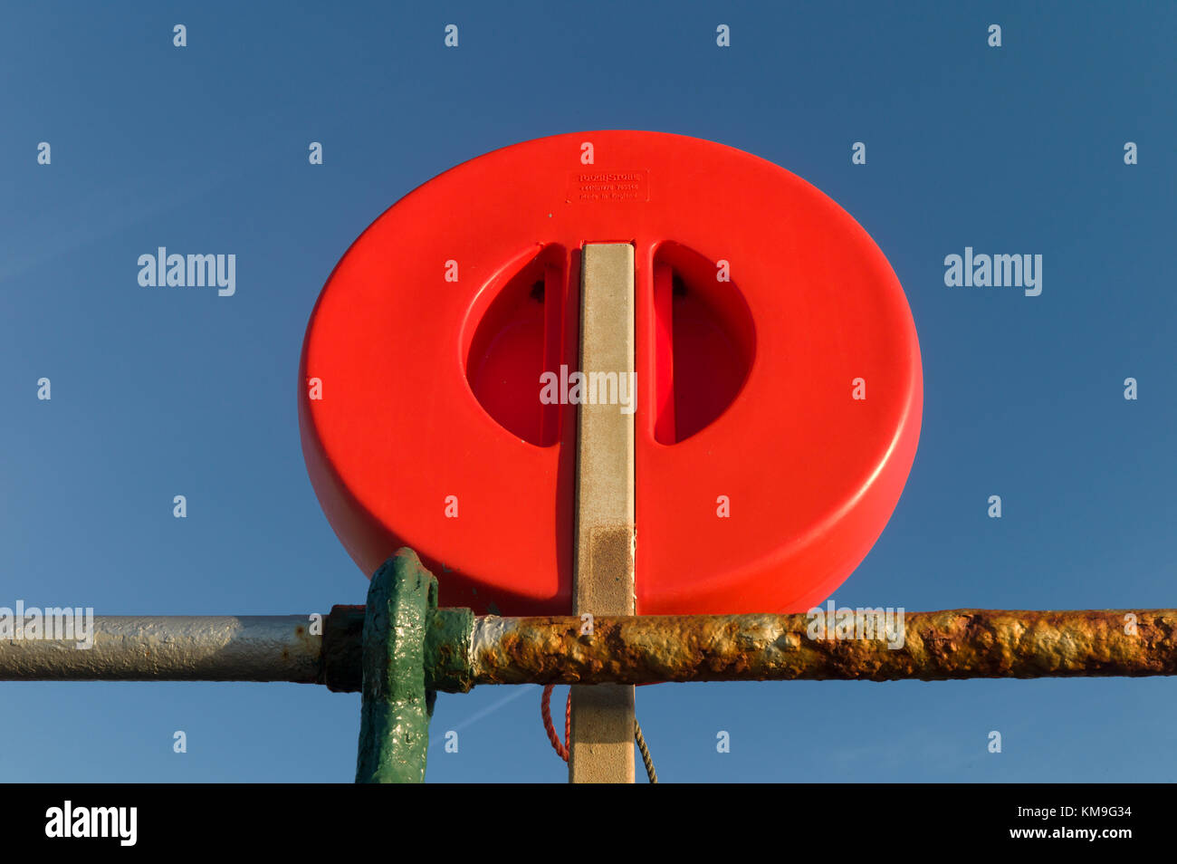 Red round lifesaver box against blue sky Stock Photo - Alamy