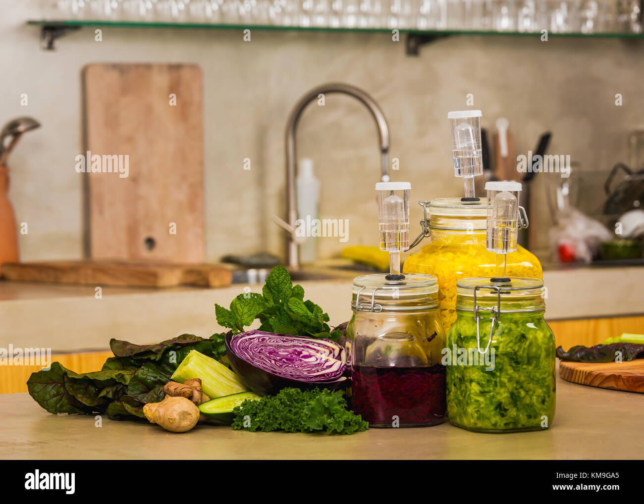 Preparing fermented preserved vegetables. Jars of cabbage kimchi and ...