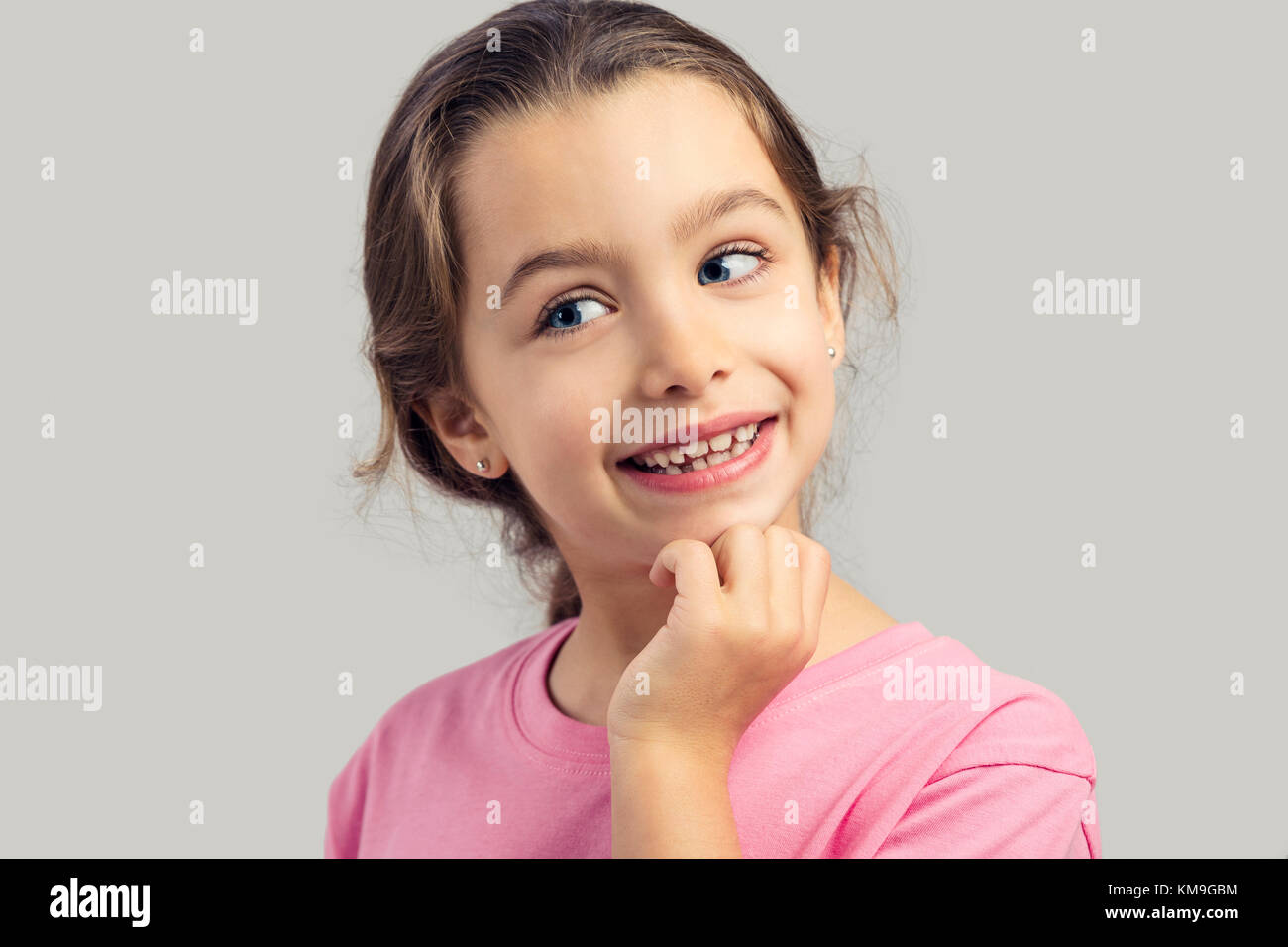Studio portrait of a beautiful little girl thinking Stock Photo - Alamy