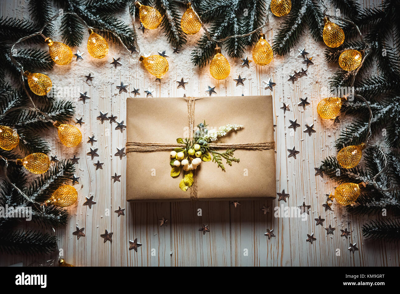 Christmas gift box with a bow and a beautiful glowing garland against ...