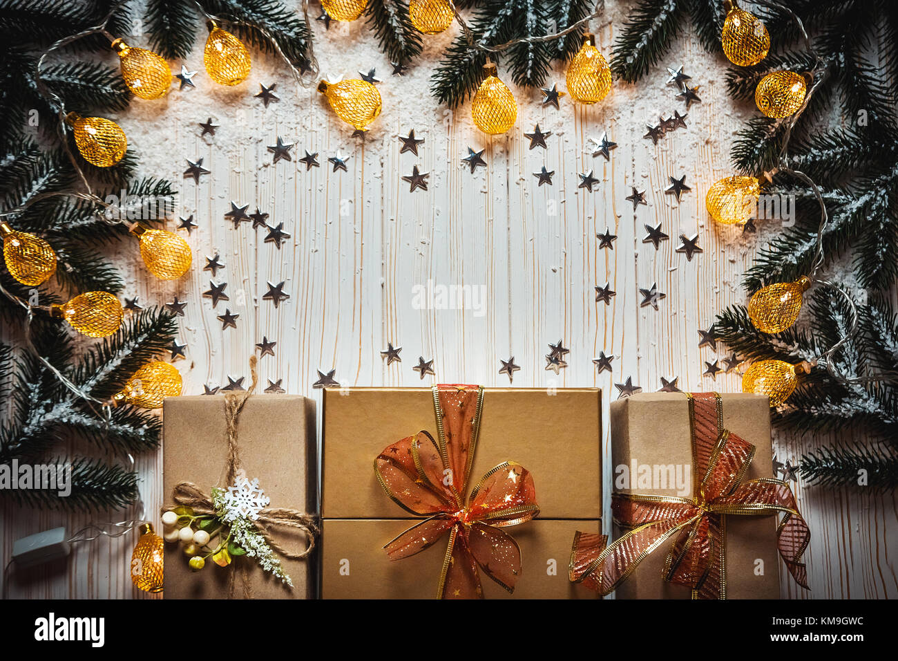 Christmas gift box with a bow and a beautiful glowing garland against ...