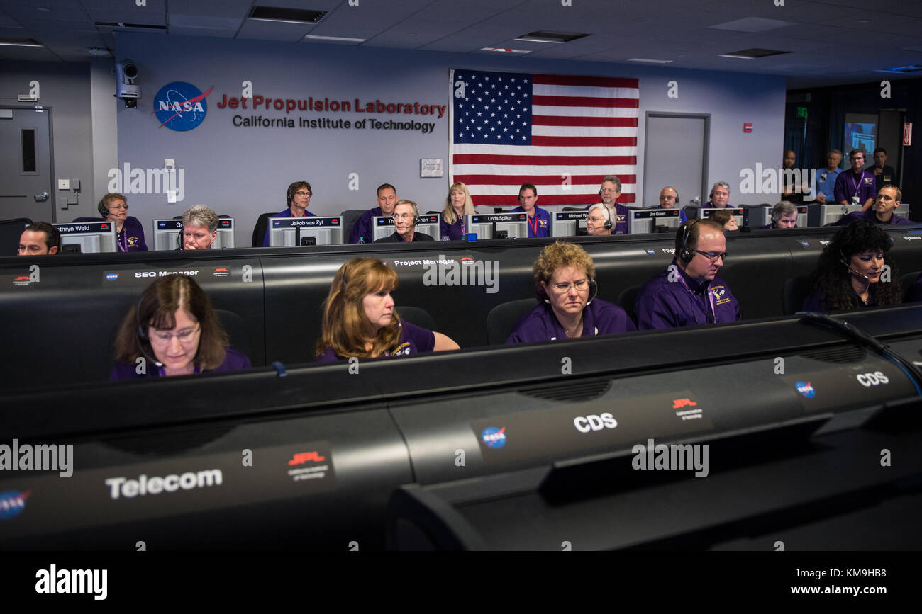 Cassini mission scientists work in the mission control room as the ...