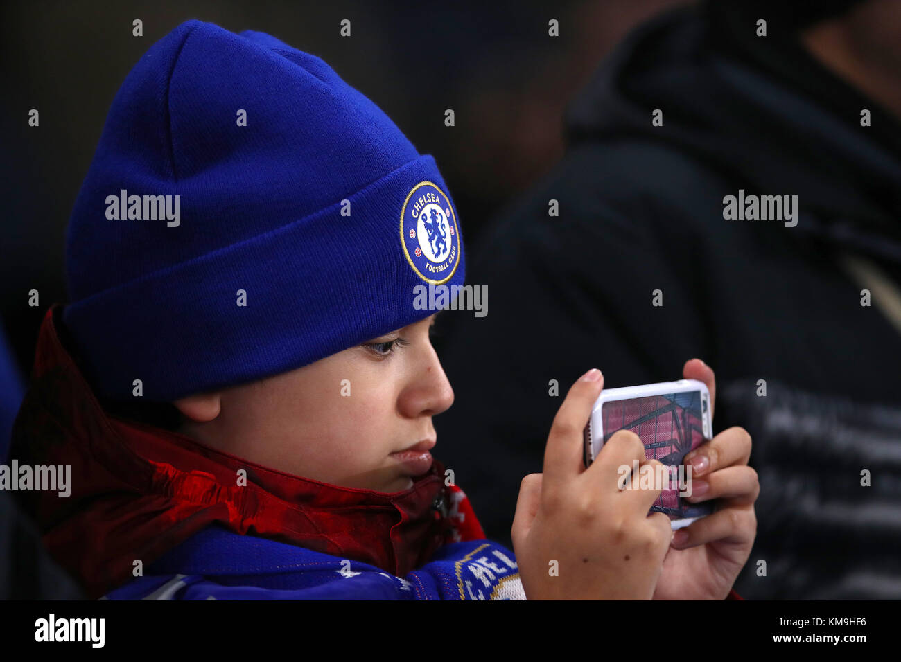 A young Chelsea fan watches the players warming up before the UEFA ...