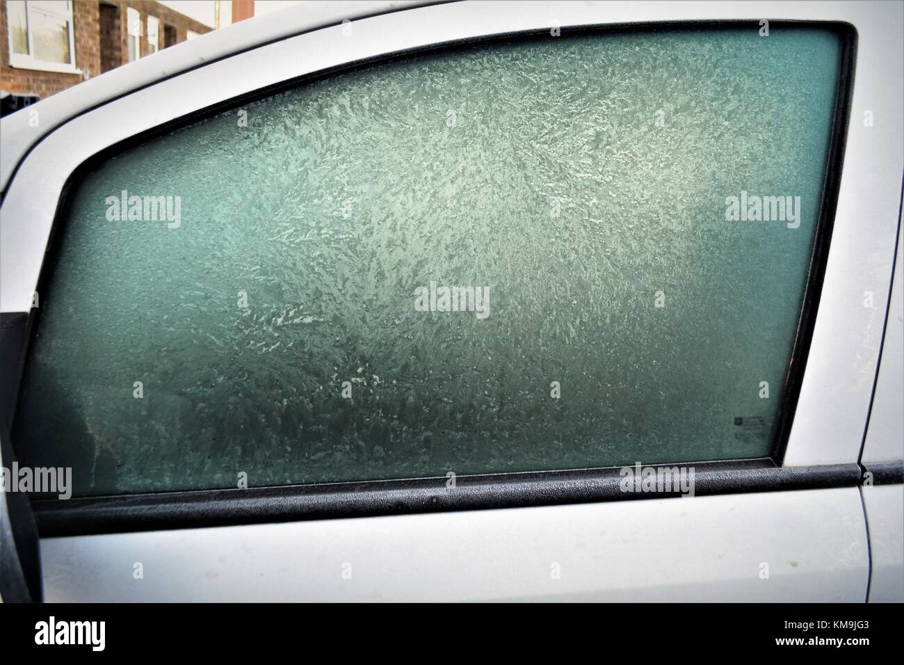 Car window covered in frost Vauxhall side window Stock Photo - Alamy