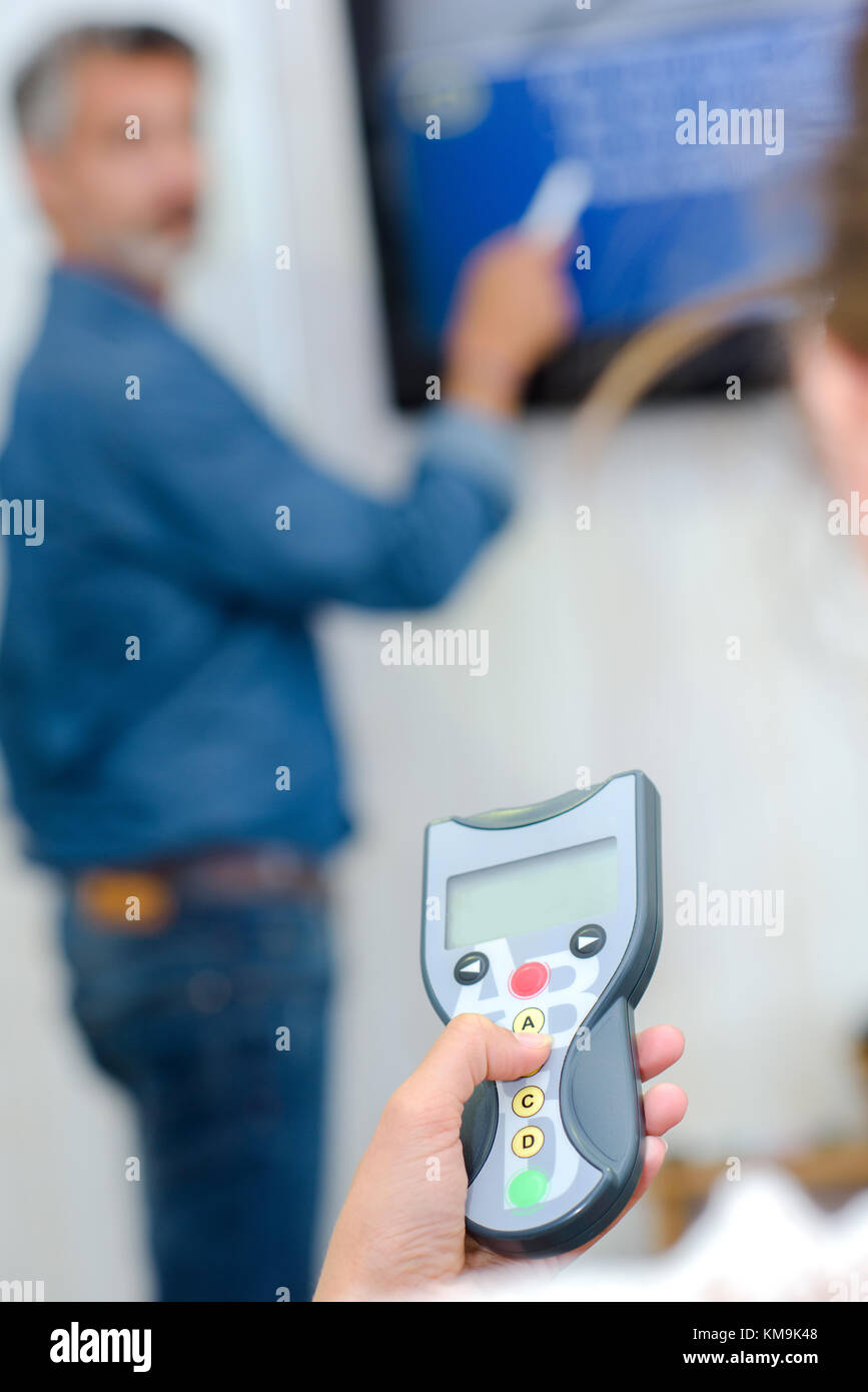 holding a remote control selector gadget Stock Photo - Alamy