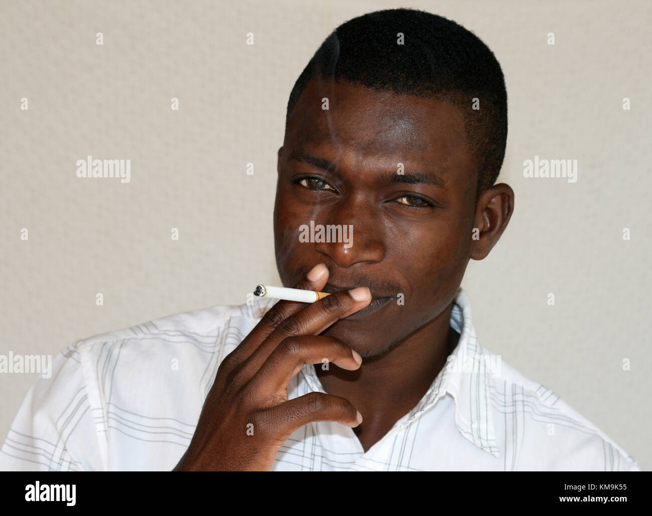 African man smoking Stock Photo - Alamy
