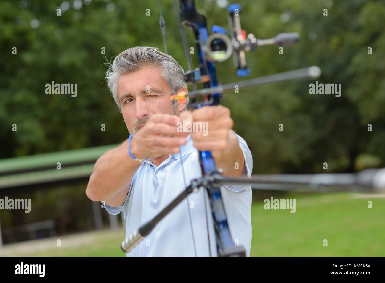 Male archer in action Stock Photo - Alamy