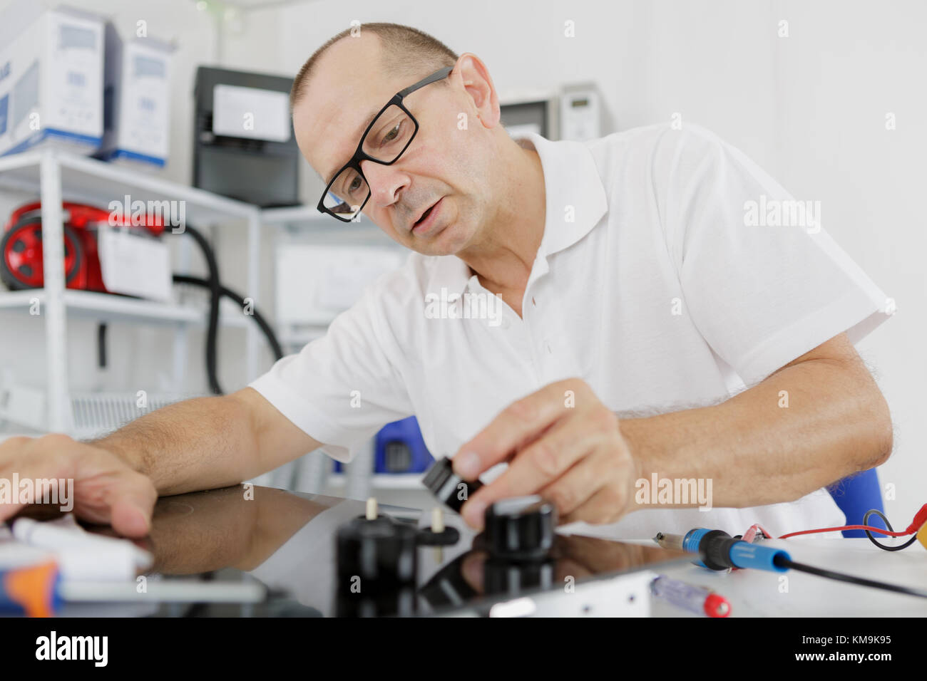 man fixing tap with tool in the kitchen at home Stock Photo - Alamy