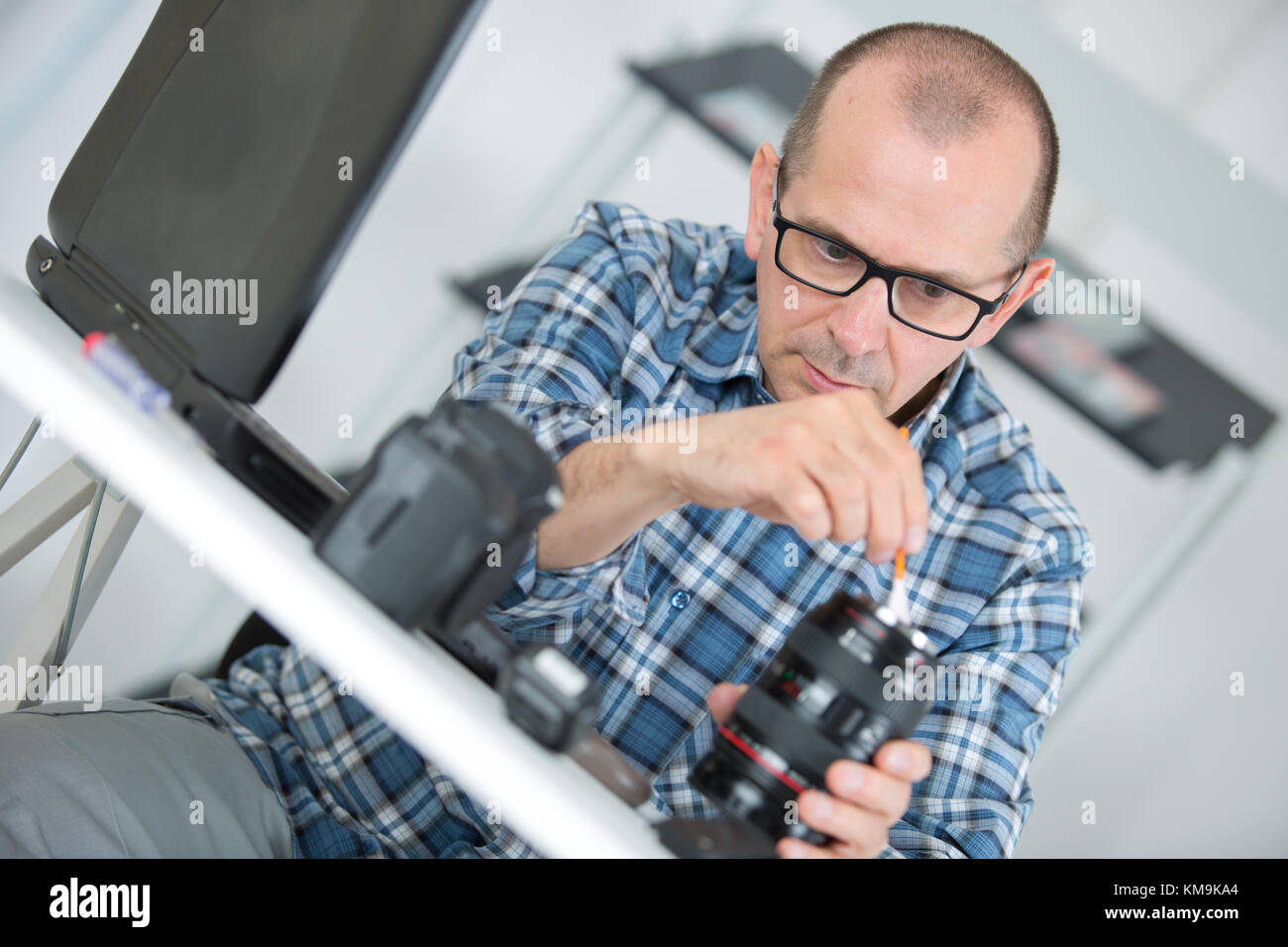 photographer inspecting the camera Stock Photo - Alamy