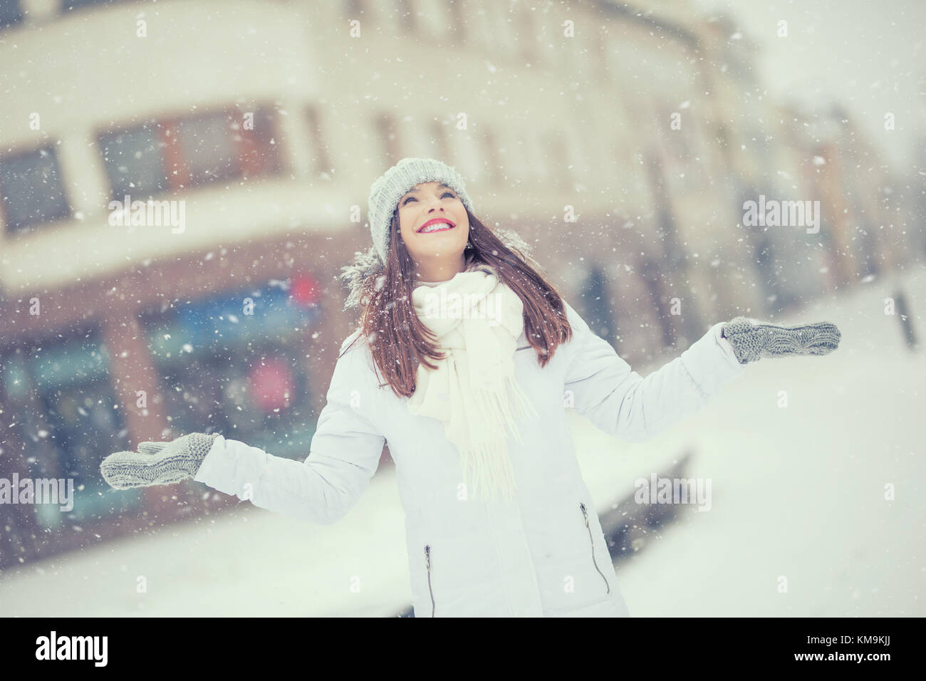 Beautiful smiling young woman in warm clothing. The concept of portrait ...