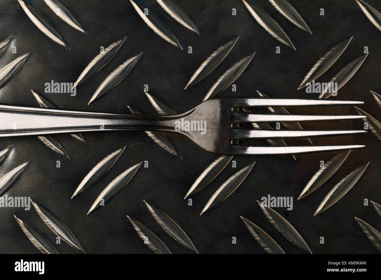 Metal fork top view on metal background Stock Photo - Alamy