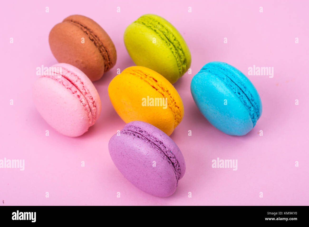 Small French macaroons on pastel background. Studio Photo Stock Photo ...
