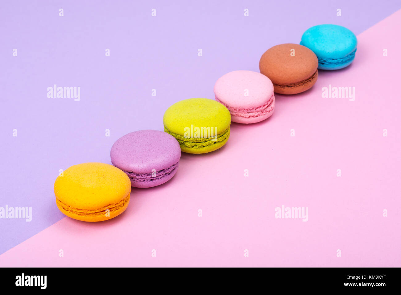 Small French macaroons on pastel background. Studio Photo Stock Photo ...