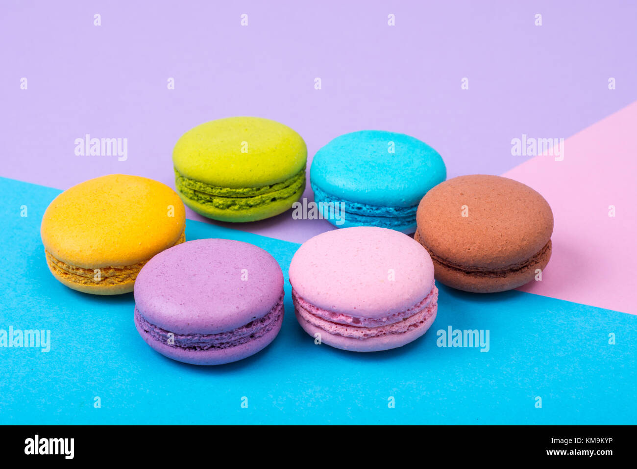 Small French macaroons on pastel background. Studio Photo Stock Photo ...
