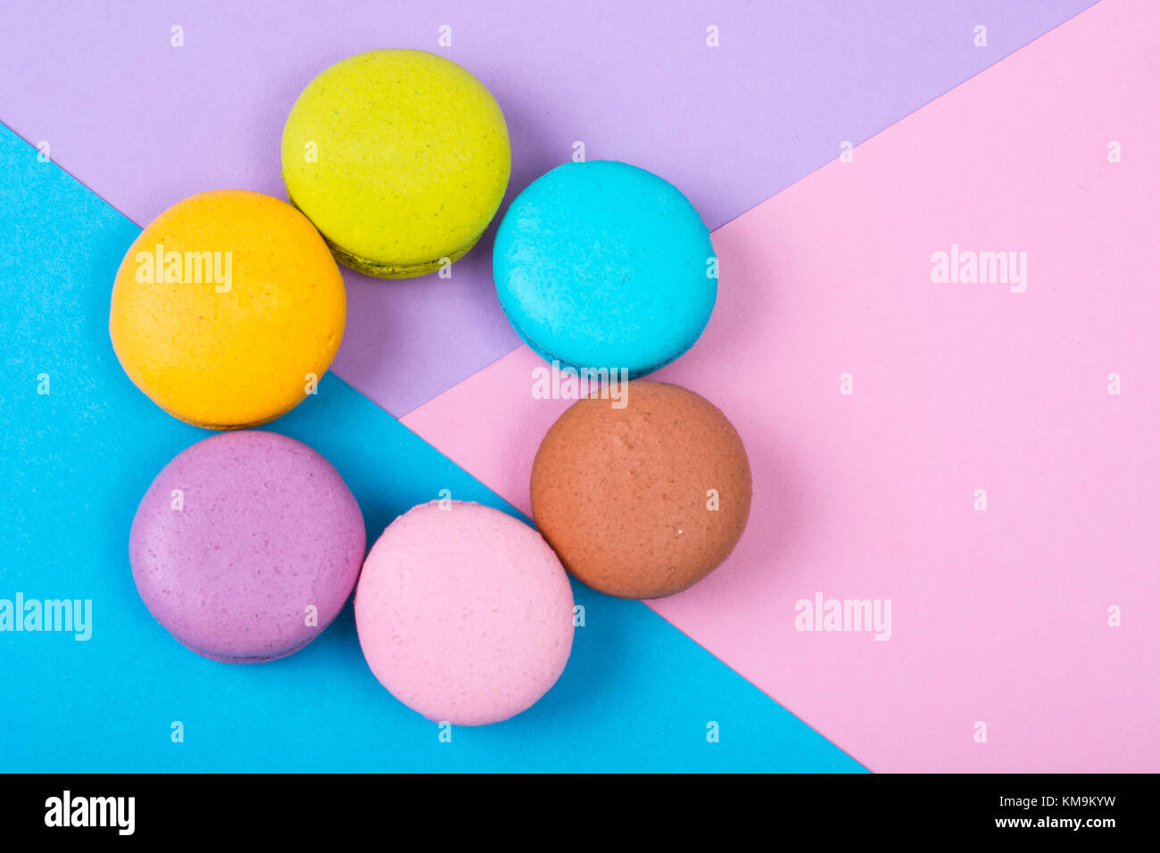 Small French macaroons on pastel background. Studio Photo Stock Photo ...