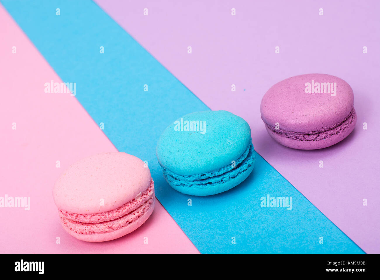 Small French macaroons on pastel background. Studio Photo Stock Photo ...