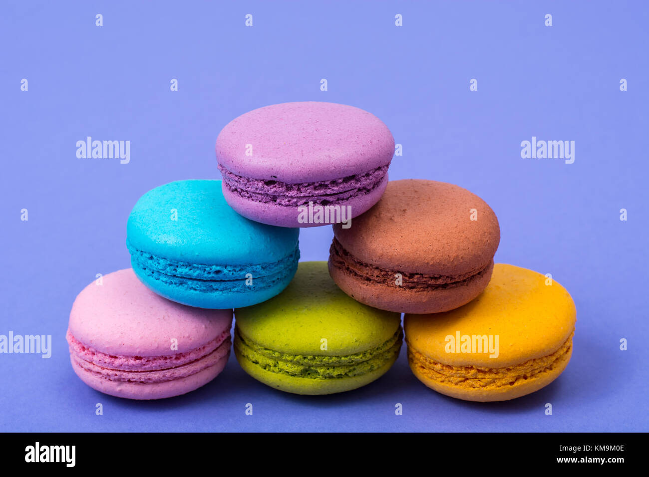 Small French macaroons on pastel background. Studio Photo Stock Photo ...