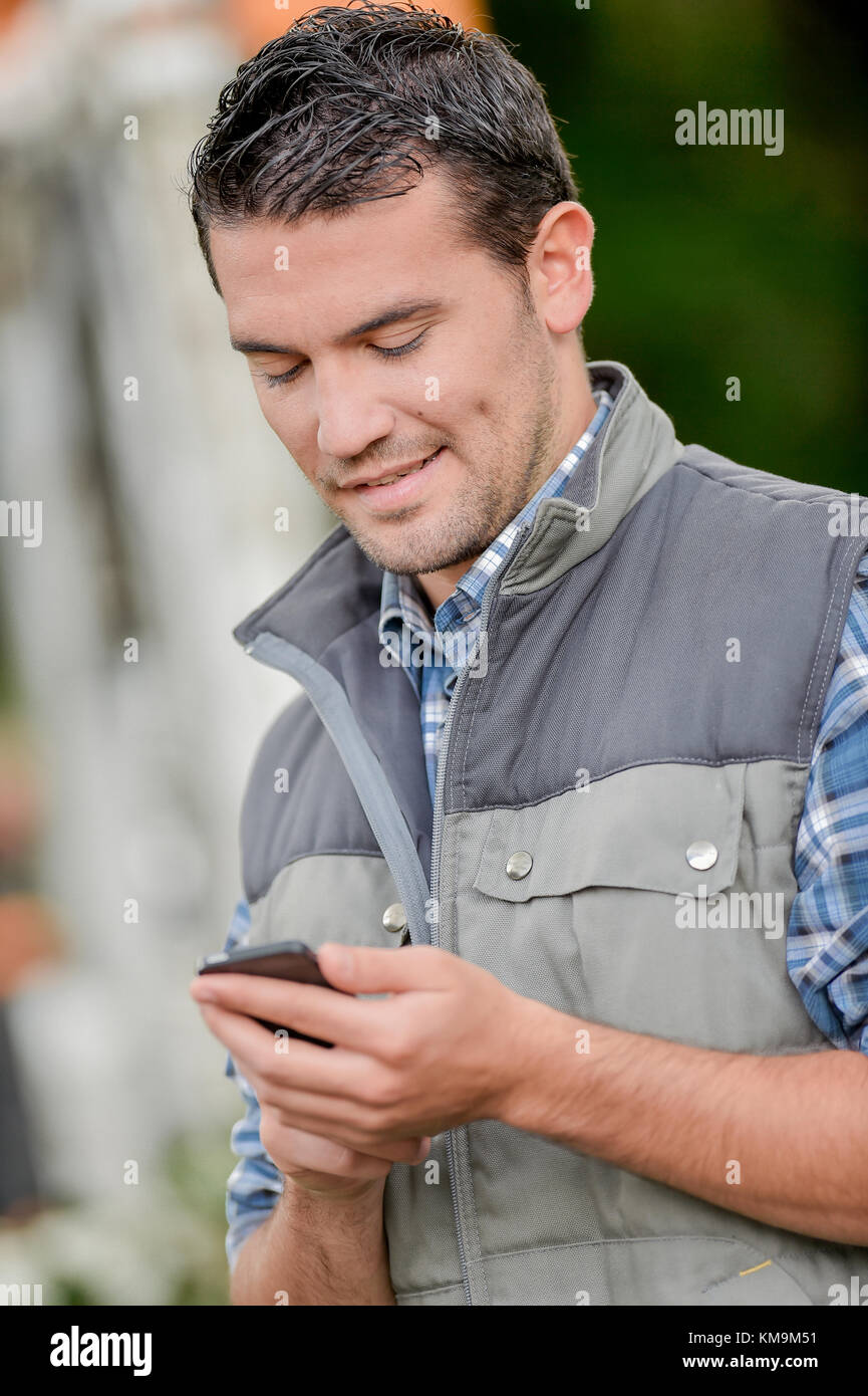 Man outdoors using cellphone Stock Photo - Alamy