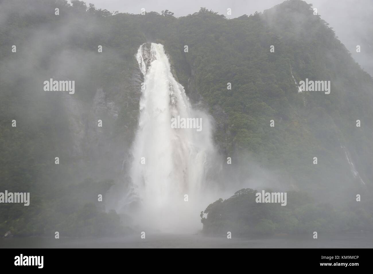 A huge waterfall falls from high altitude into the Milford Sound. (24 ...