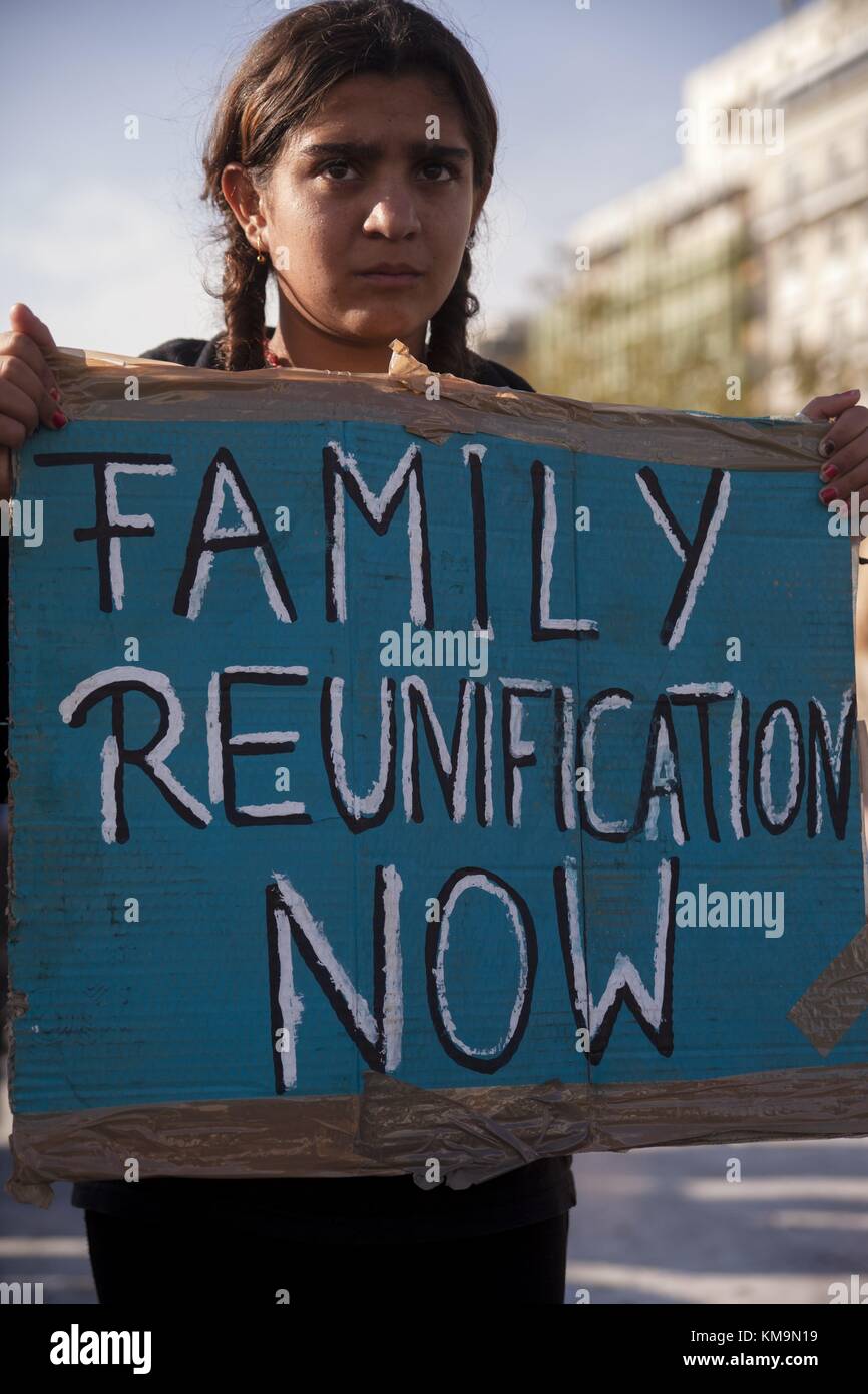Refugee child with sign "Family reunification now". Refugees demand ...