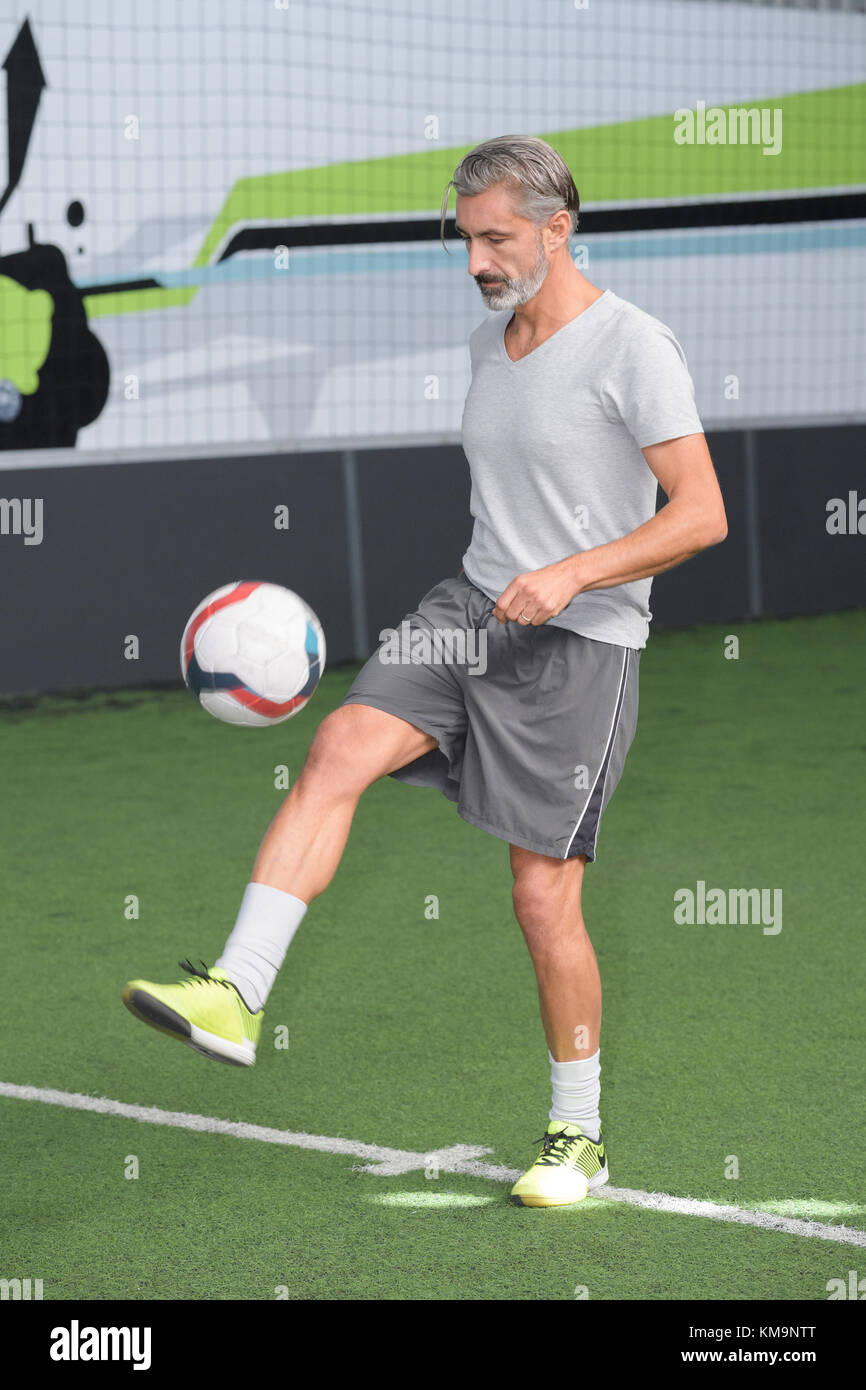 man playing football alone Stock Photo - Alamy