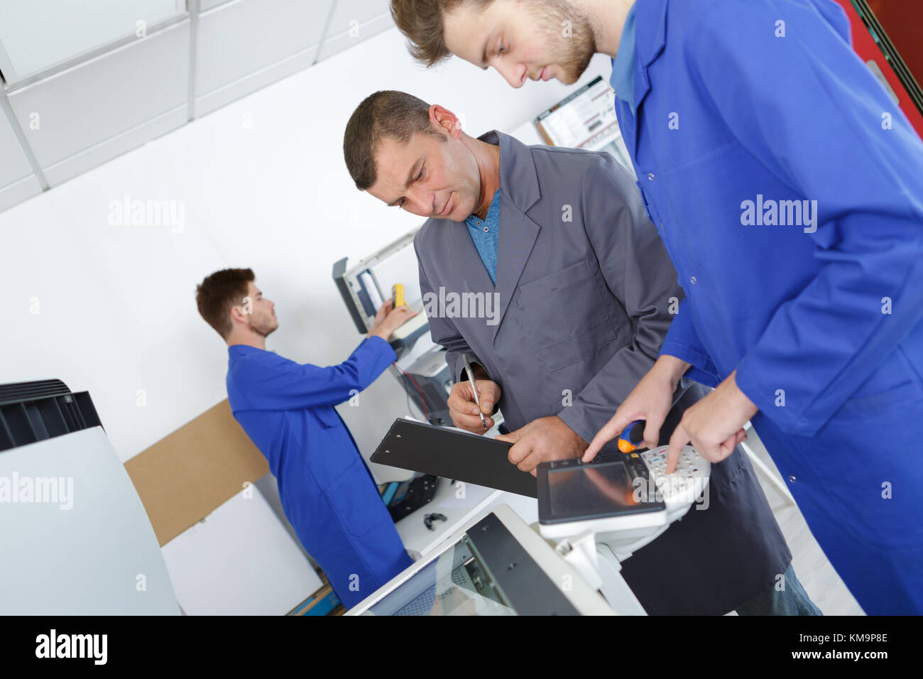young printer technician checking issues Stock Photo - Alamy