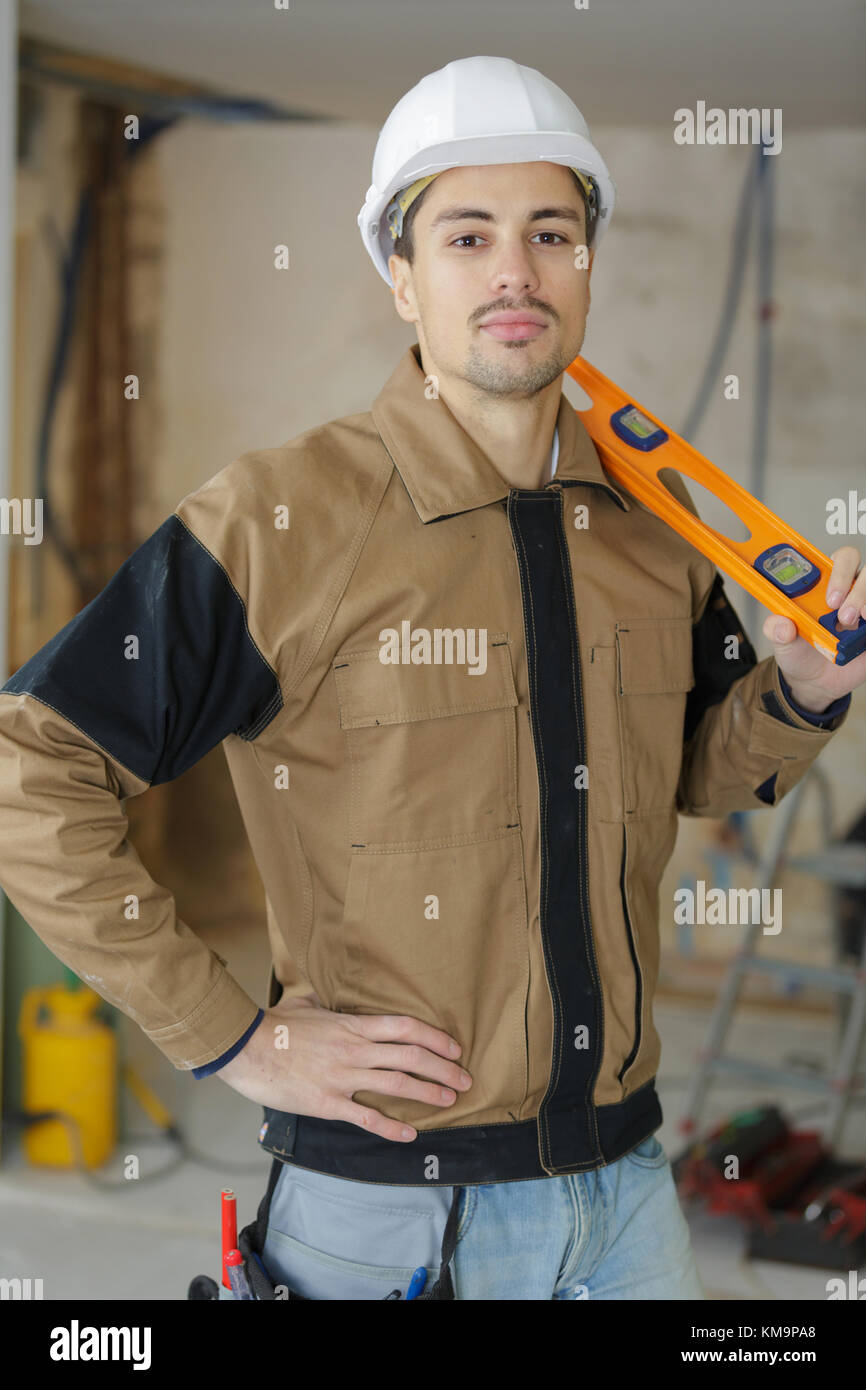 Portrait of tradesman, spirit level on shoulder Stock Photo - Alamy