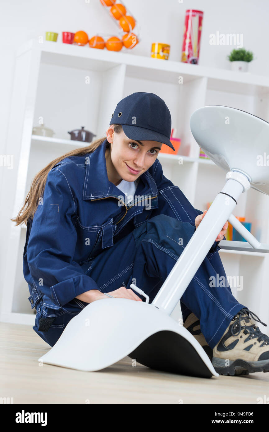 female worker fixing a chair Stock Photo - Alamy