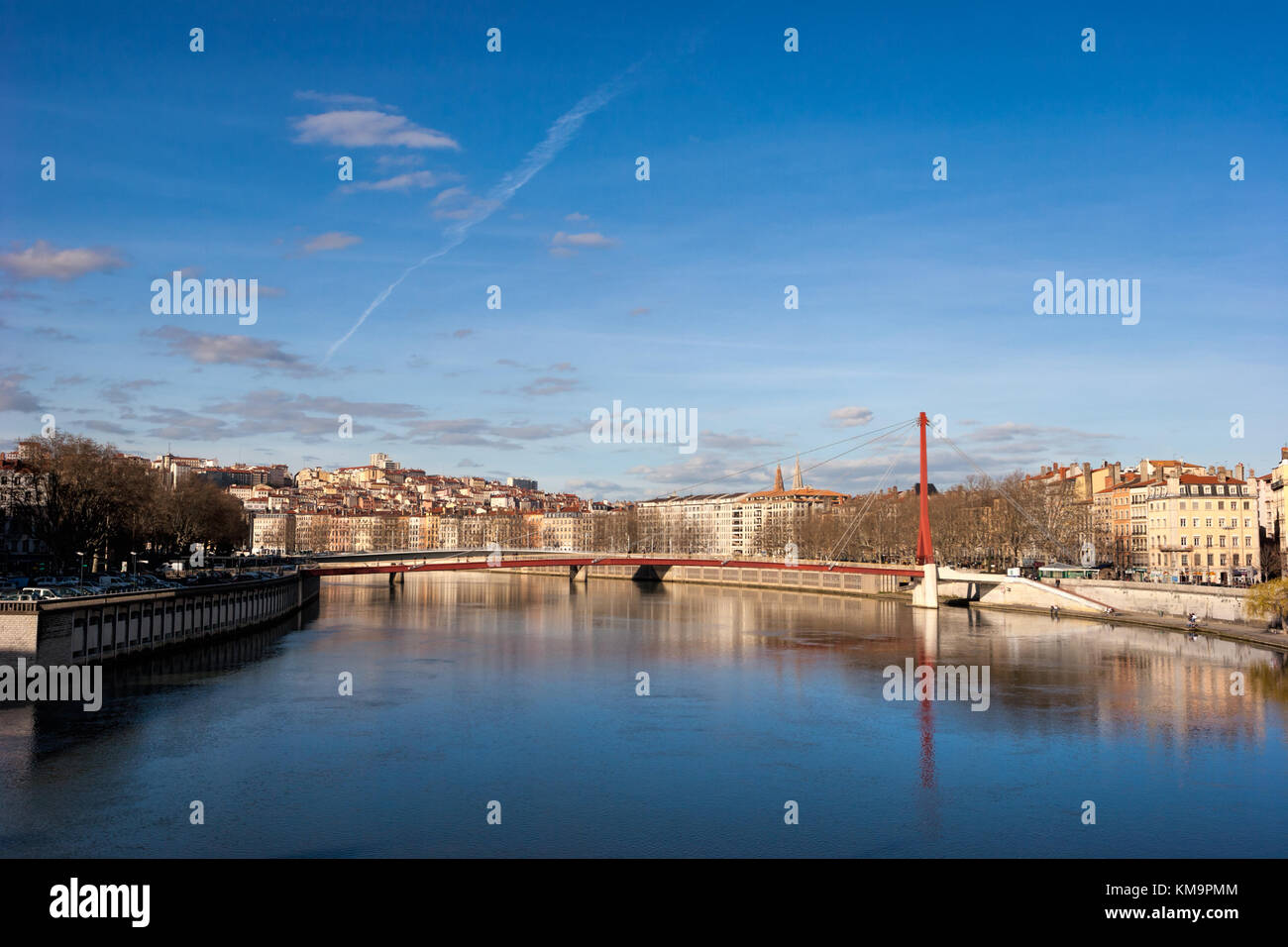 Lyon citycsape with red suspension footbridge over the Saone river and ...
