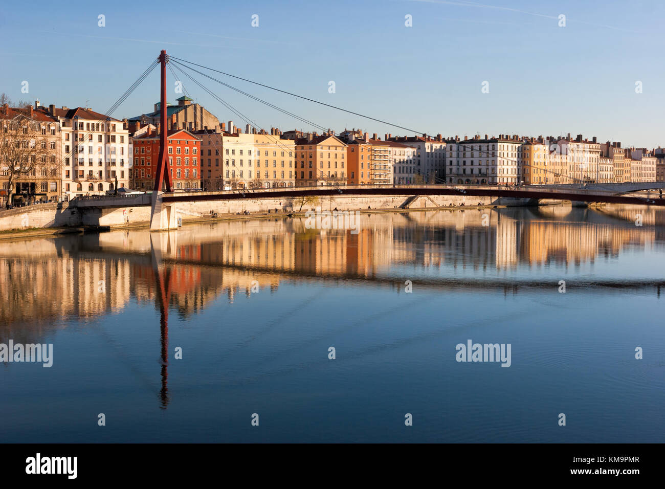 Lyon citycsape with red suspension footbridge over the Saone river and ...