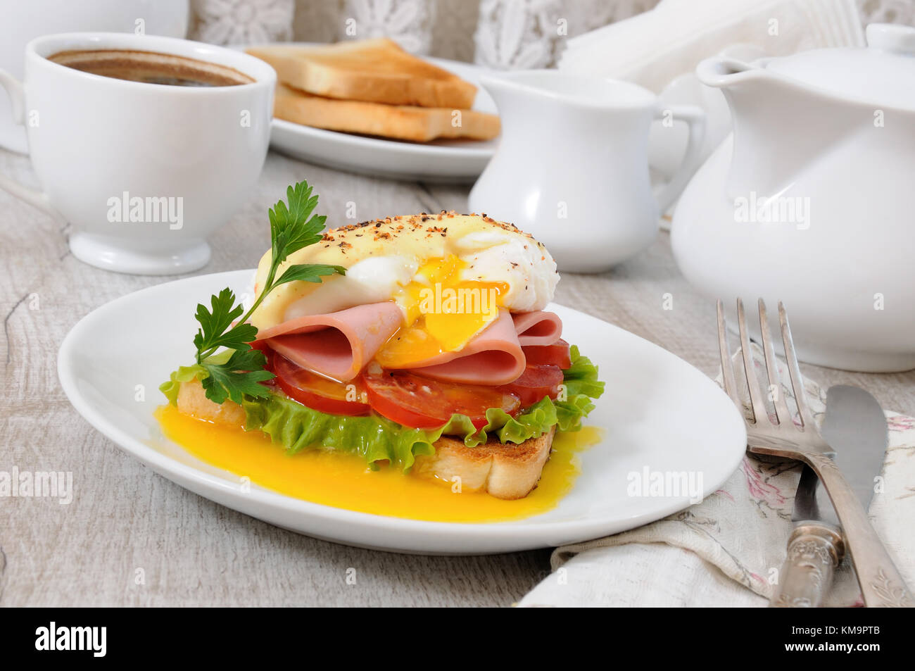 Toast with slices of ham and tomatoes, Benedict egg with Dutch sauce ...