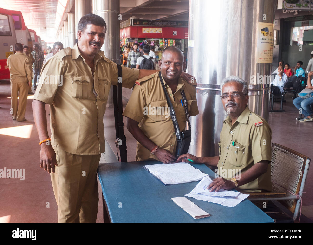 Portrait of bus conductors along with an official at the bus station of ...