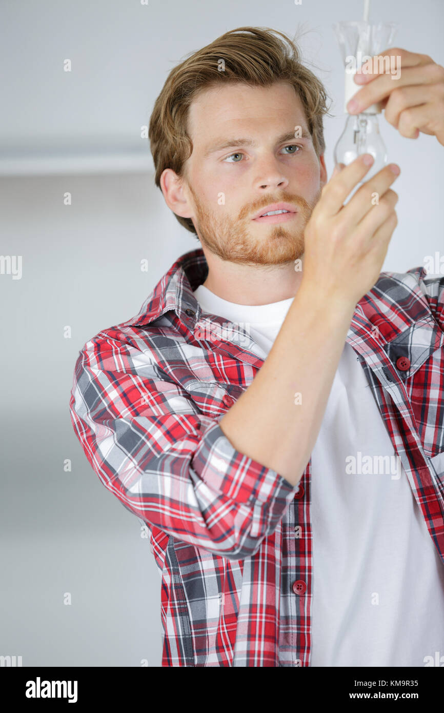 Man Changing Light Bulb Stock Photos & Man Changing Light Bulb Stock ...