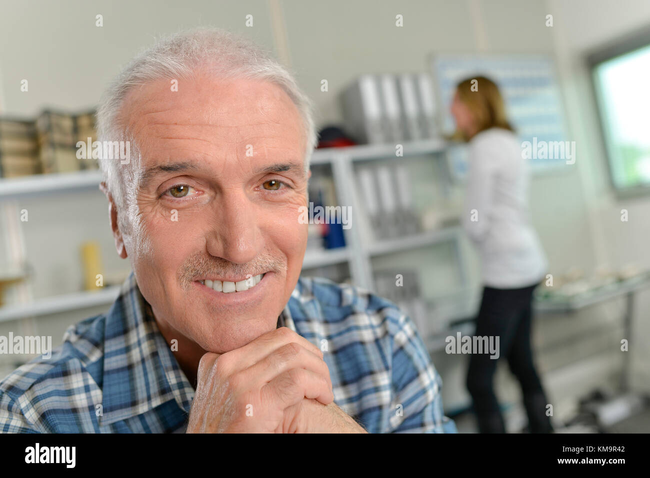 Senior office worker smiling Stock Photo - Alamy