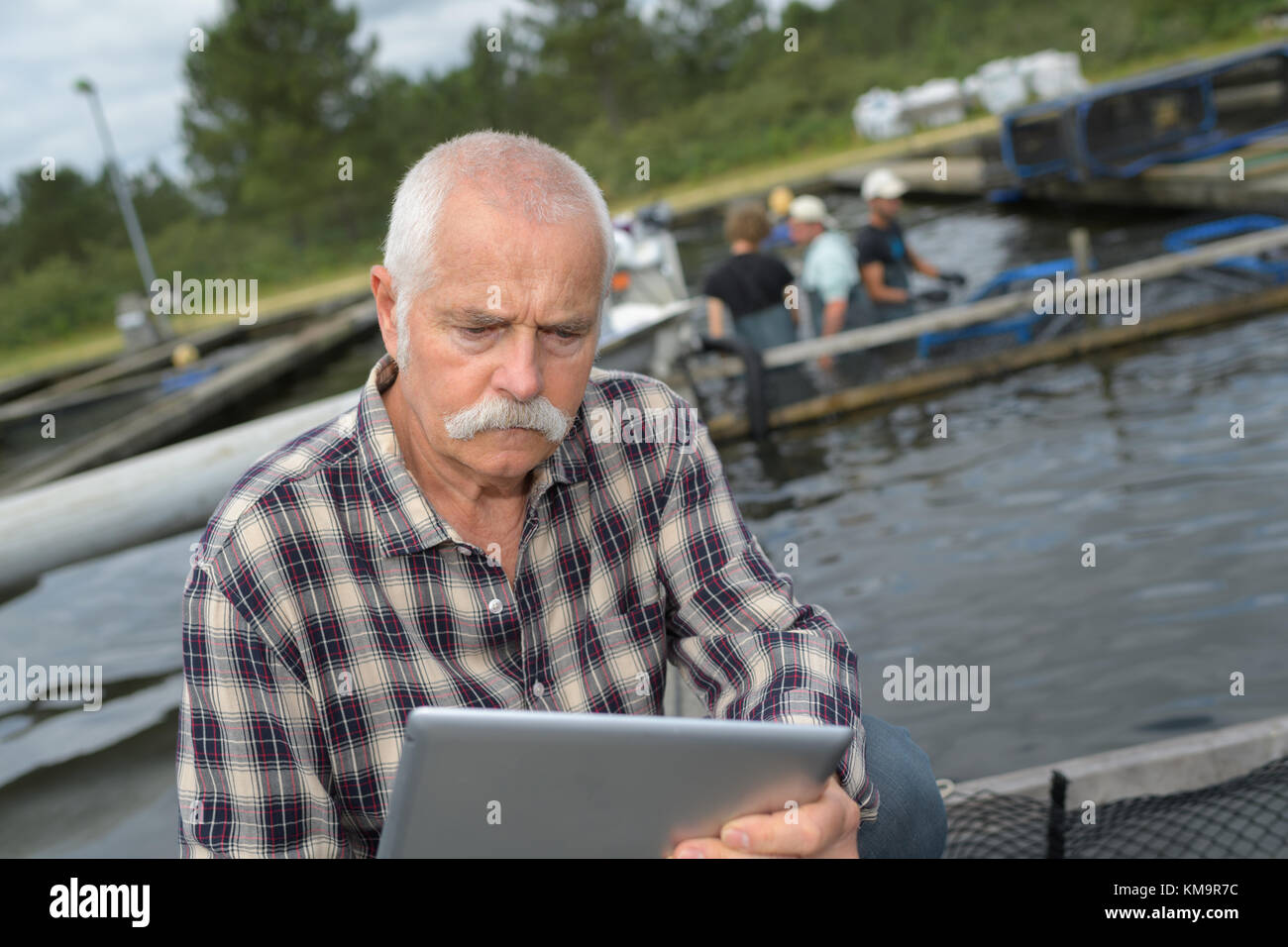 senior worker using tablet in water treatment plant Stock Photo - Alamy