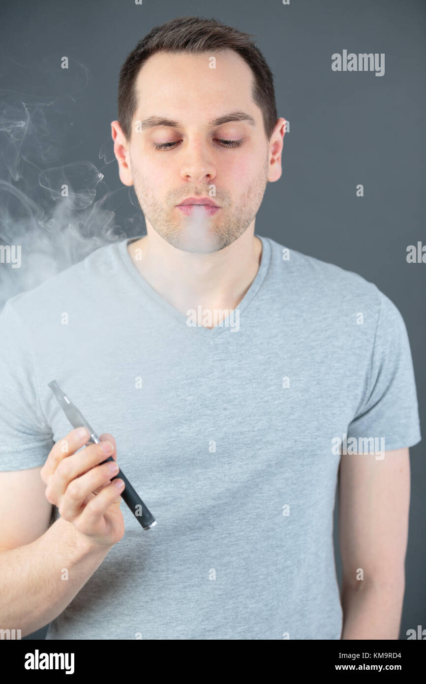 young man vaping - electronic cigarette concept Stock Photo - Alamy