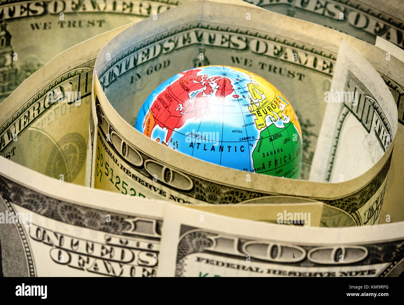 money taken over the world into a tight knot Stock Photo - Alamy