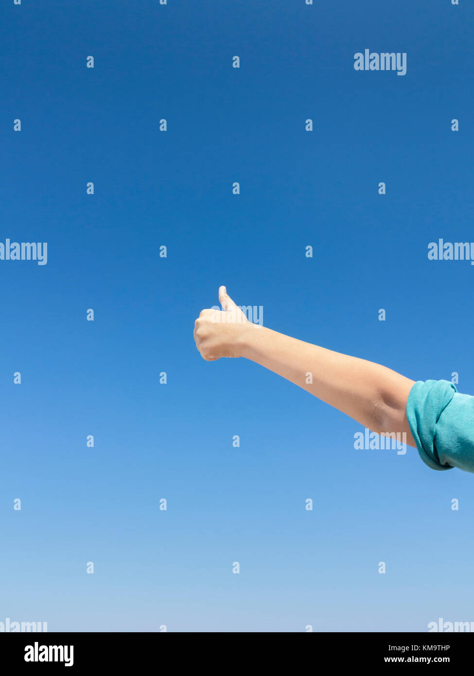 Thumbs up sign against a blue sky Stock Photo - Alamy