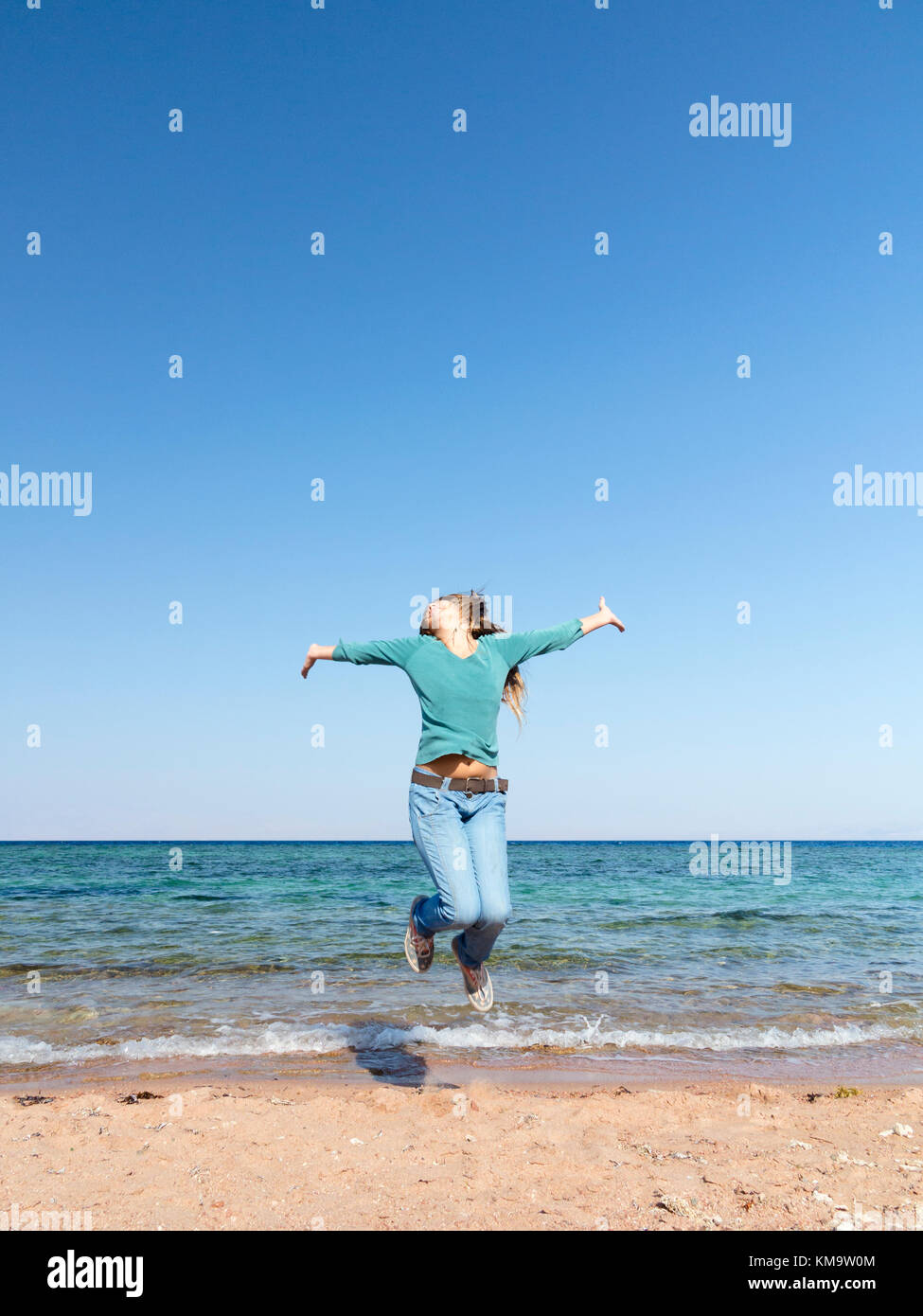Young girl jumping mid air Stock Photo - Alamy