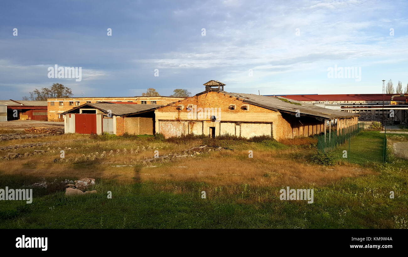 Abandoned broken down factory building made of old bricks with uncut ...