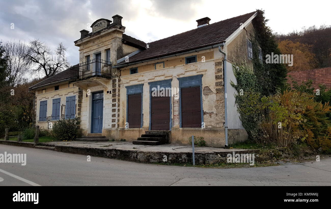 Closed small local shop building with two entrances, closed window ...