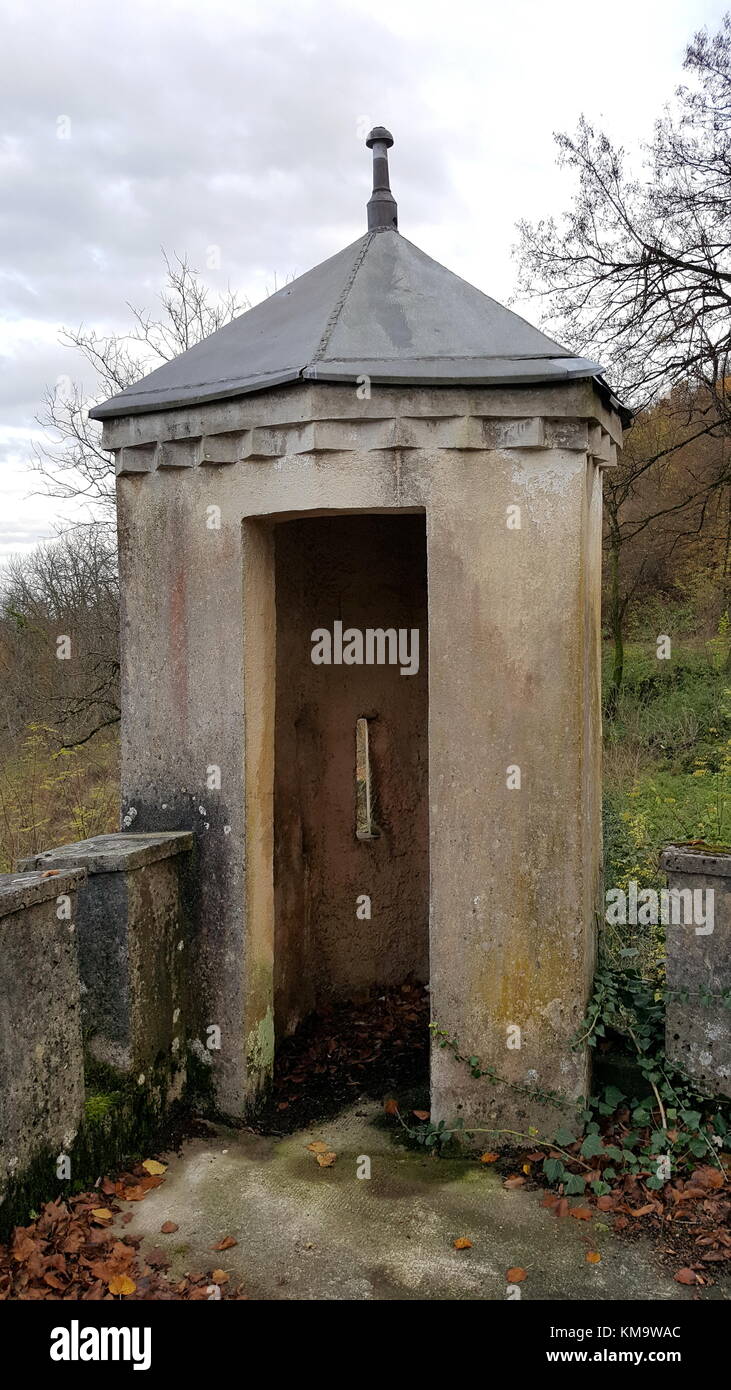 Stone castle guard tower with metal roof and small openings on sides ...