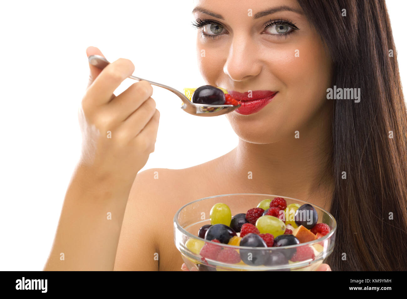 Beautiful young woman eating fresh fruit salad Stock Photo - Alamy