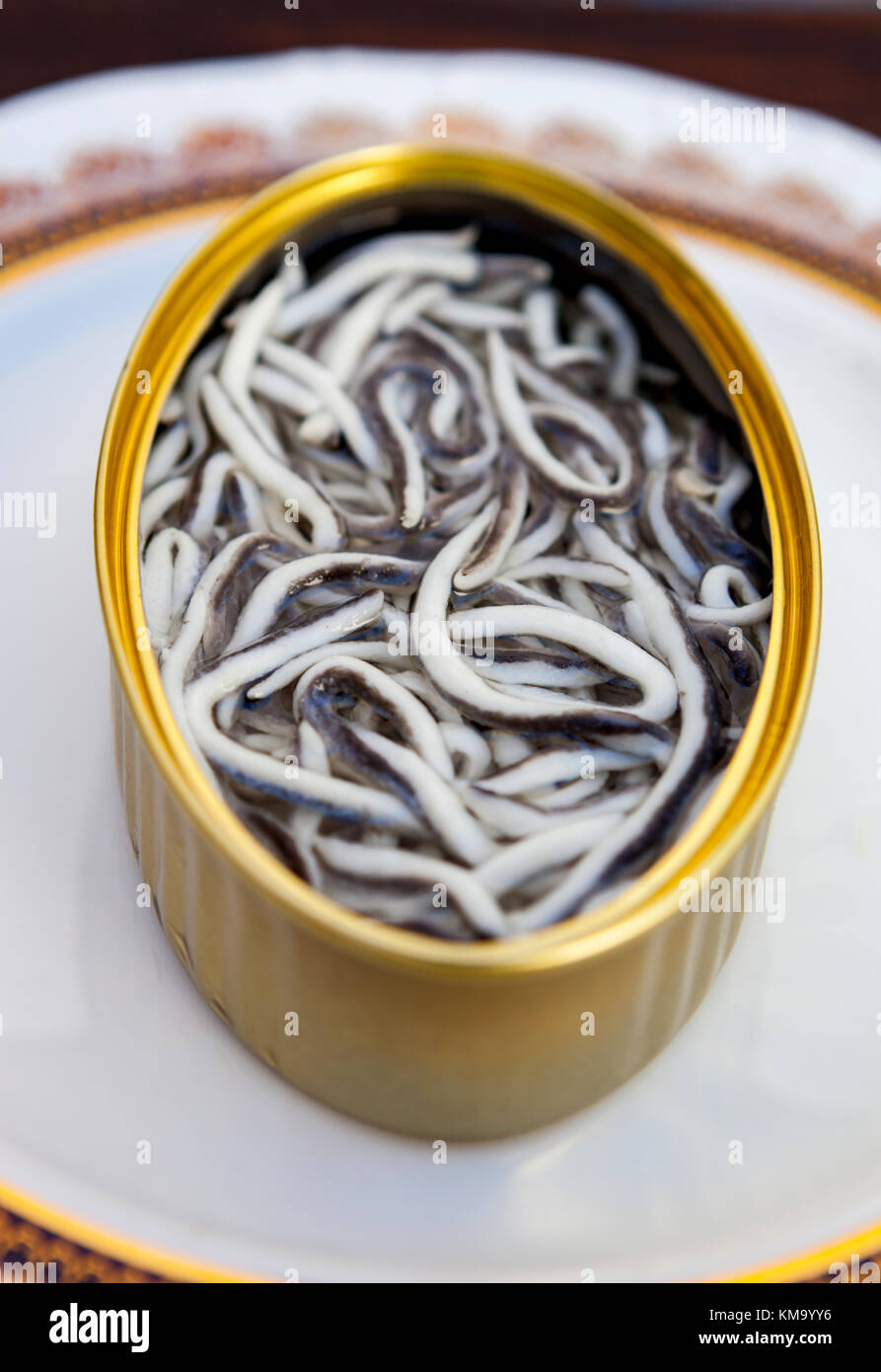 Canister of canned elvers on a elegant dish Stock Photo - Alamy